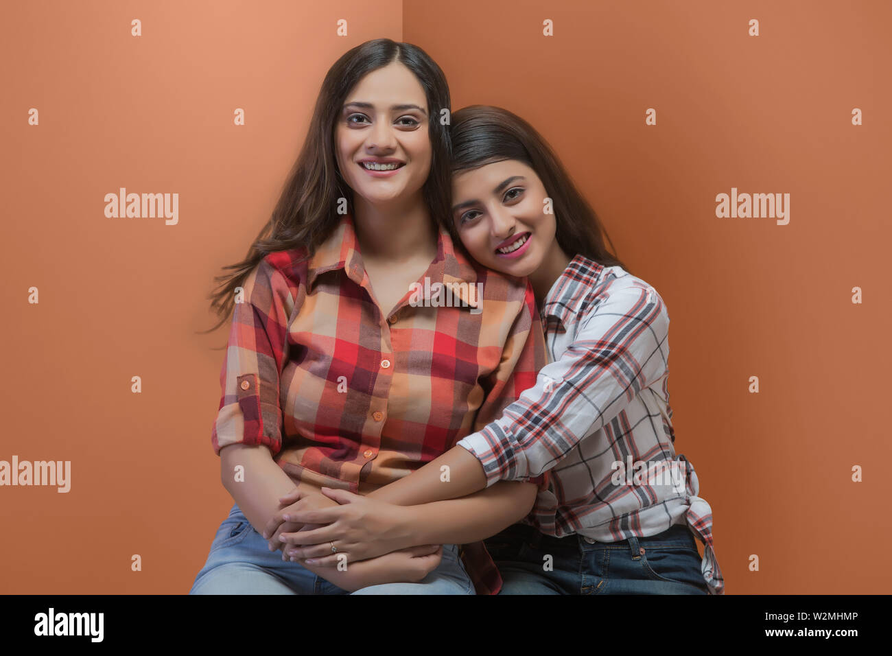 Studio shot of smiling young teenager girls hugging each other Stock ...