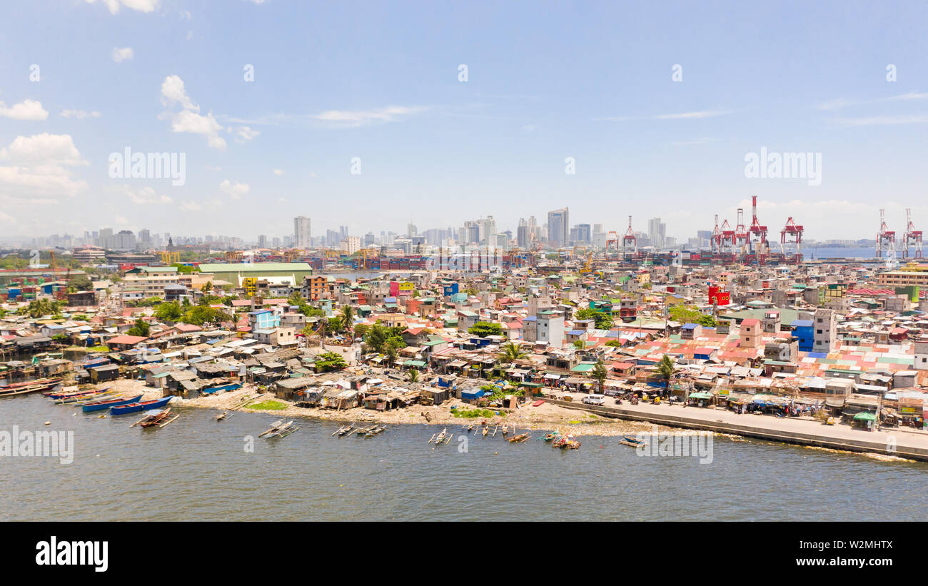 The urban landscape of Manila, with slums and skyscrapers. Sea port and ...
