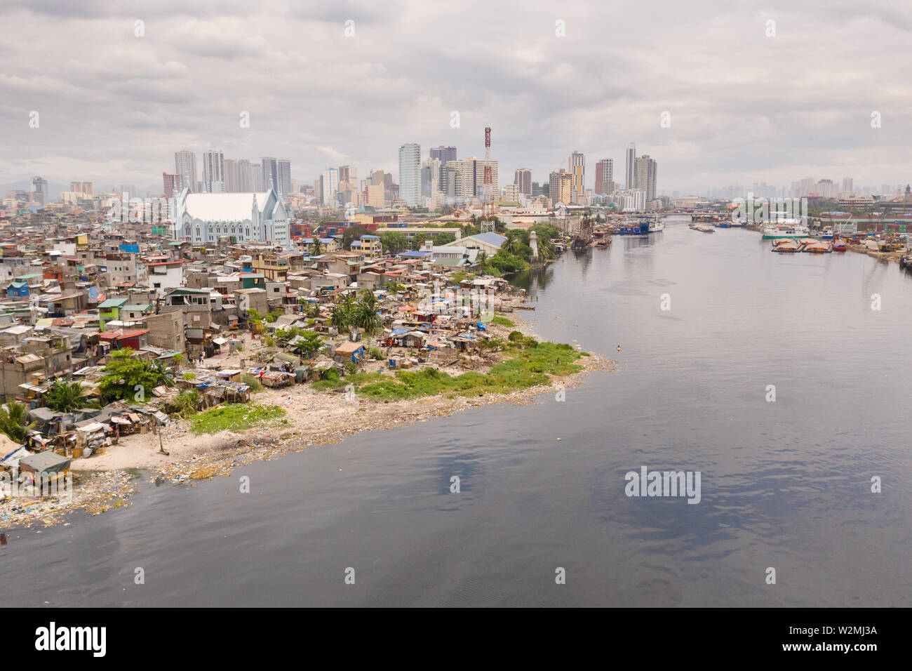 The urban landscape of Manila, with slums and skyscrapers. Sea port and residential areas. The ...