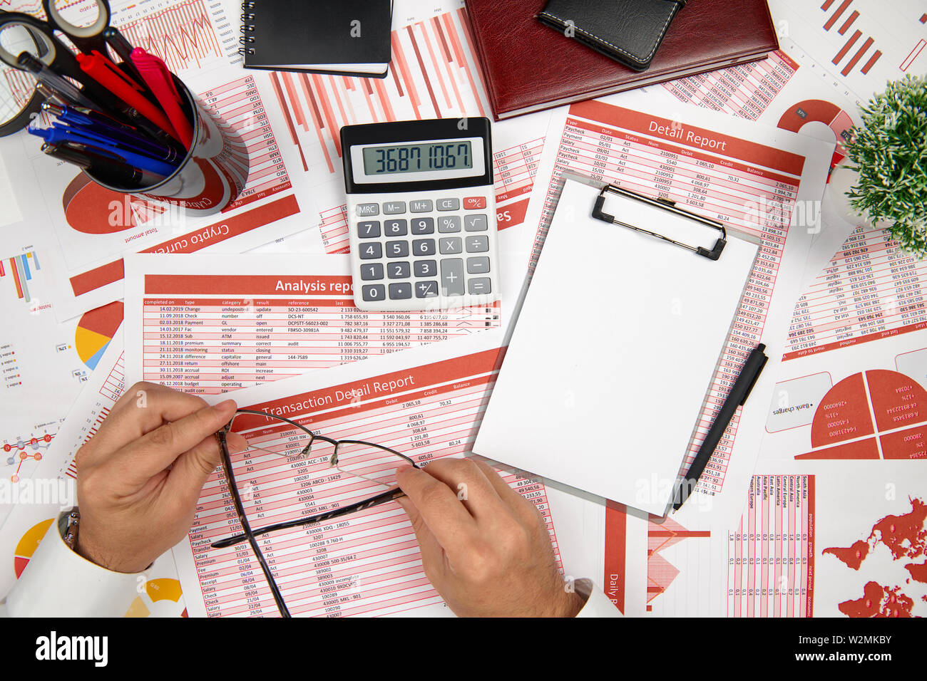 Business reports, blank paper sheet, data tables and charts - directly ...