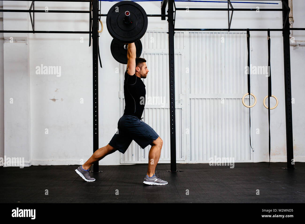 Side view of muscular athlete during weightlifting exercise Stock Photo ...