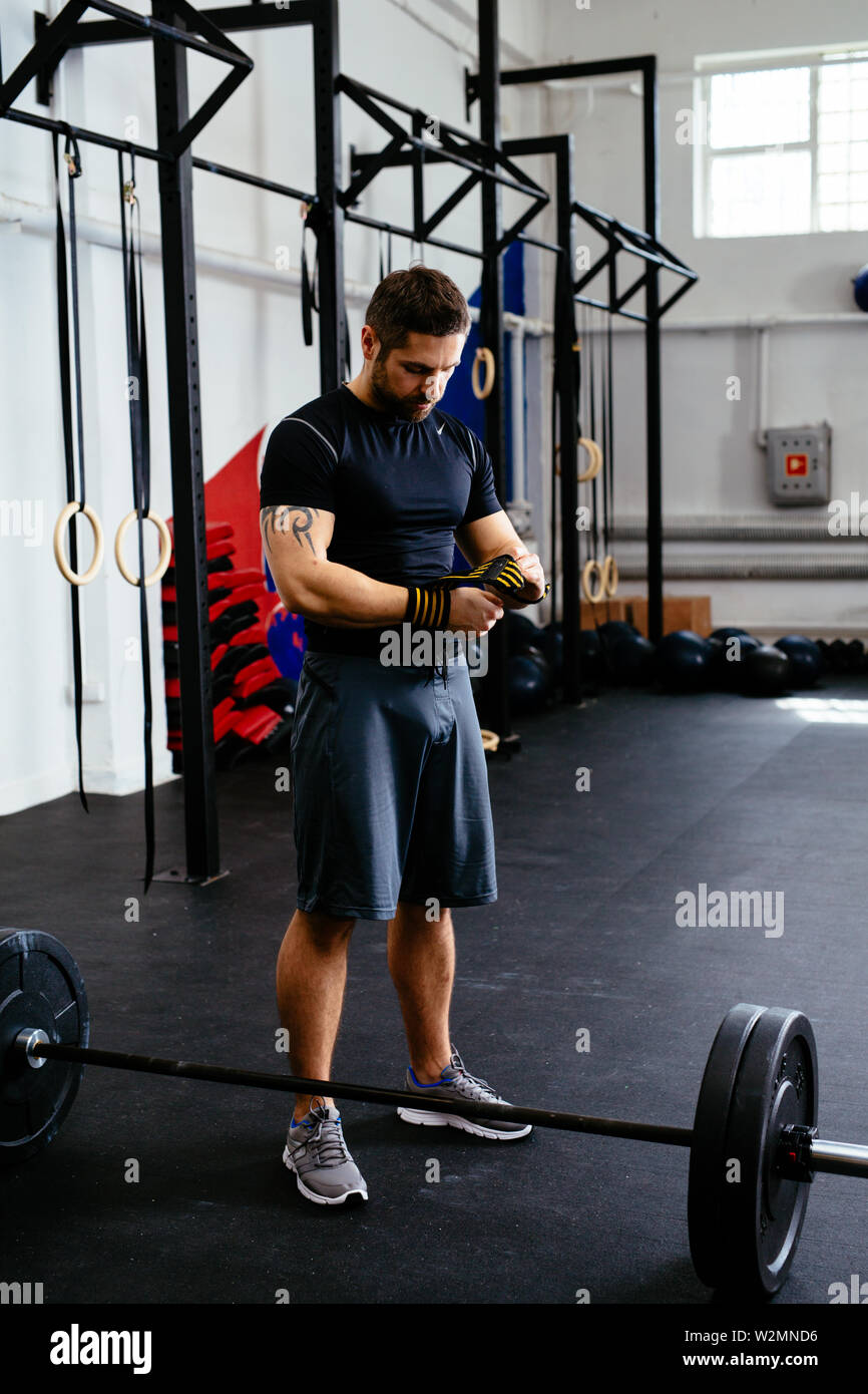 Handsome athletic man preparing before lifting weights in gym Stock ...