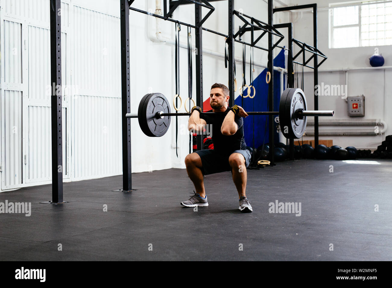Athletic man training with weights during gym workout Stock Photo - Alamy