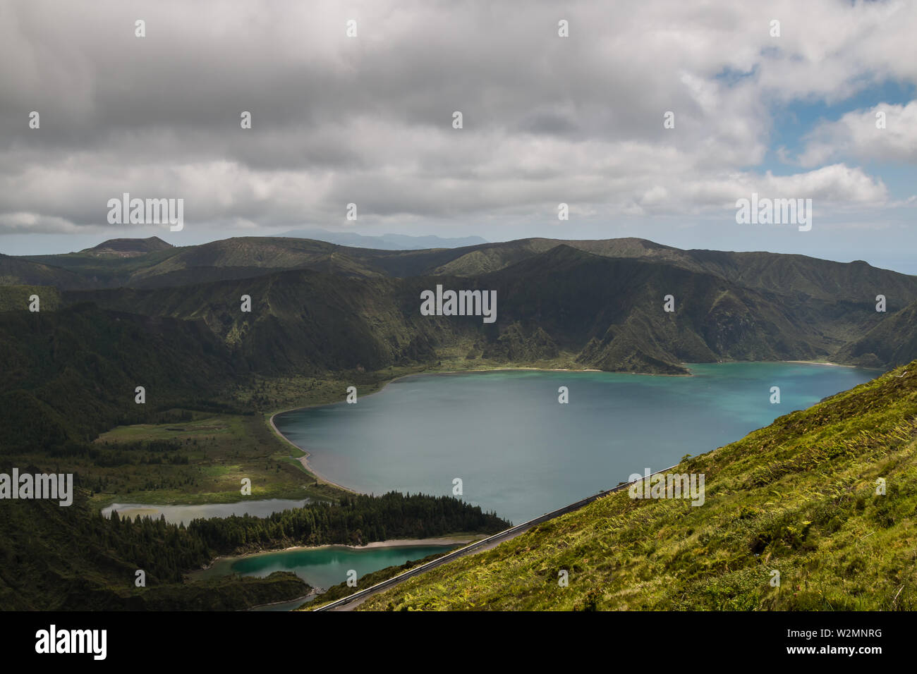 Lake Lagoa do Fogo in the volcano crater, surrounded by hills covered ...