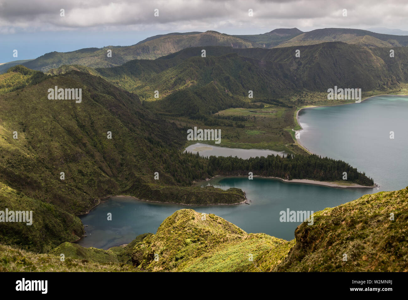 Lake Lagoa do Fogo in the volcano crater, surrounded by hills covered ...