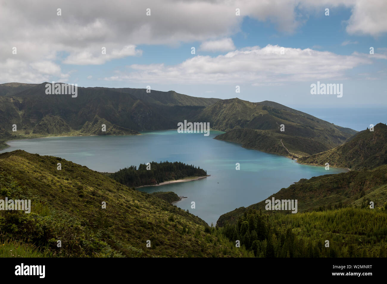 Lake Lagoa do Fogo in the volcano crater, surrounded by hills covered ...