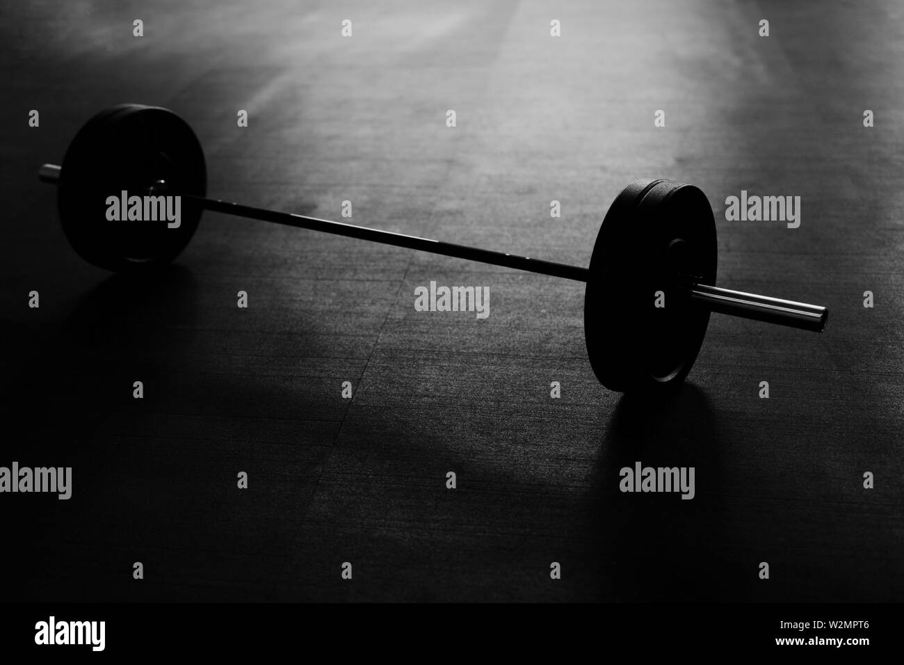 Black and white picture of barbells on the gym floor Stock Photo - Alamy