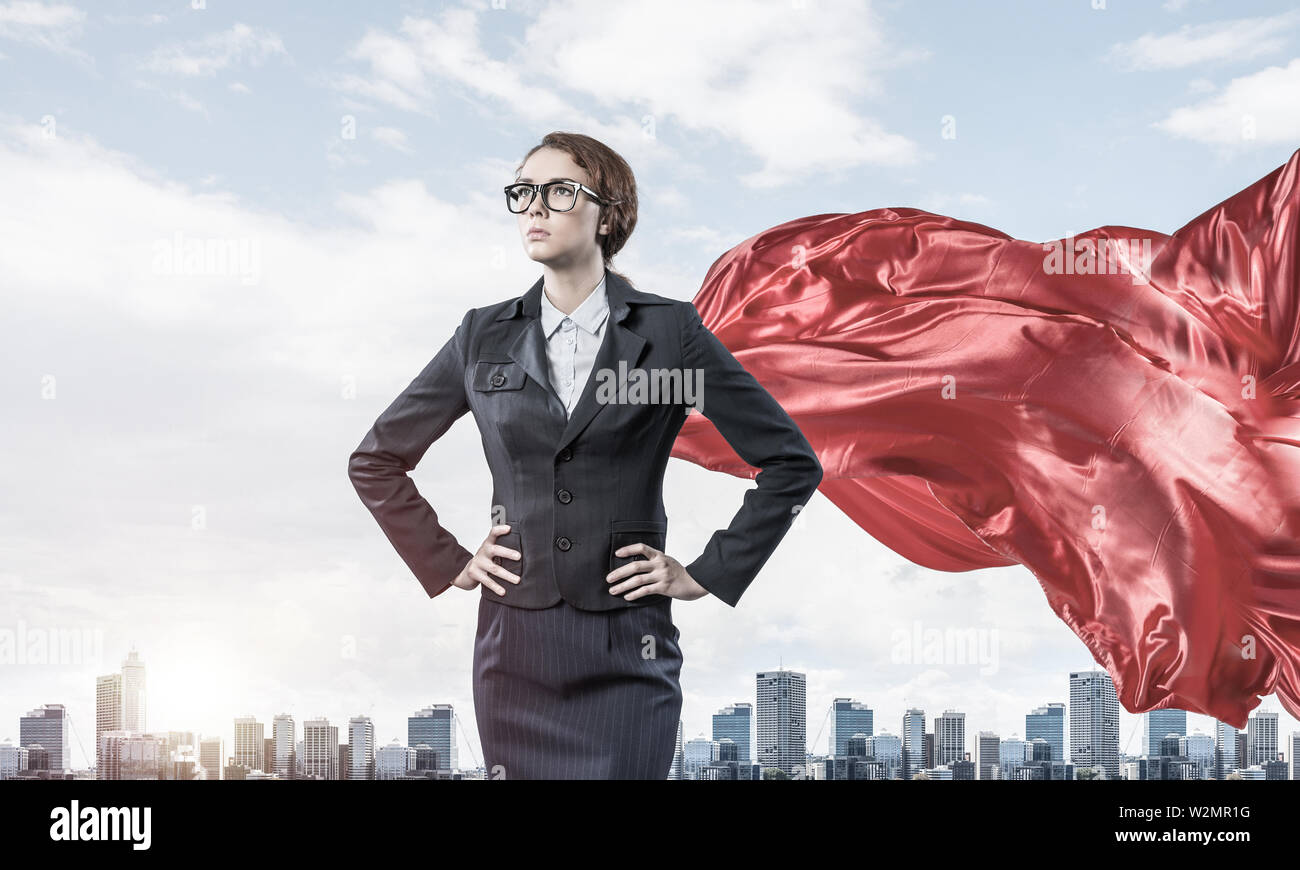 Concept of power and sucess with businesswoman superhero in big city ...