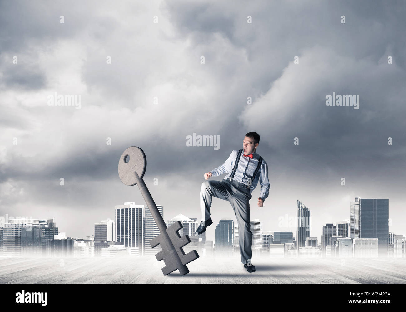 Breaking through access concept with furious man crashing concrete key ...