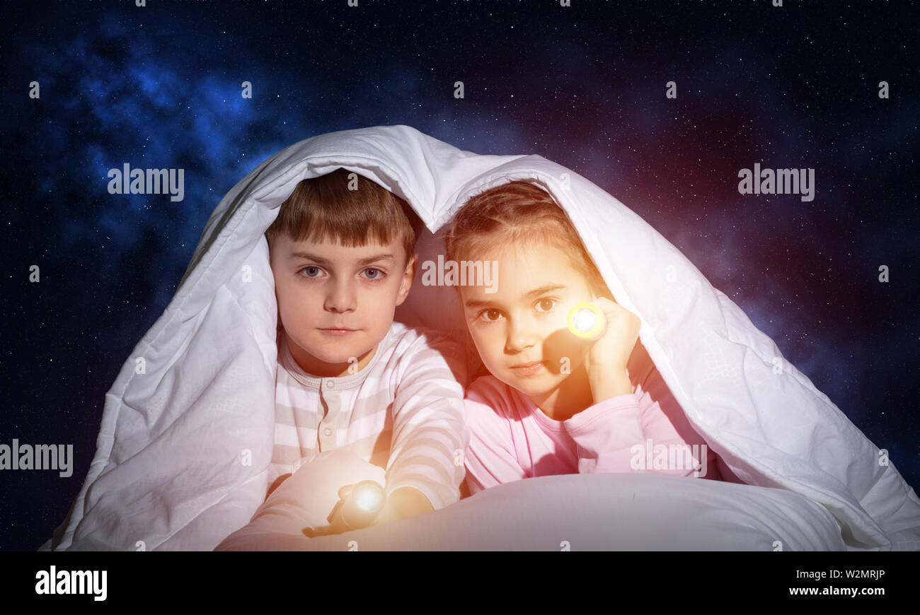 Children with flashlights in bed Stock Photo - Alamy