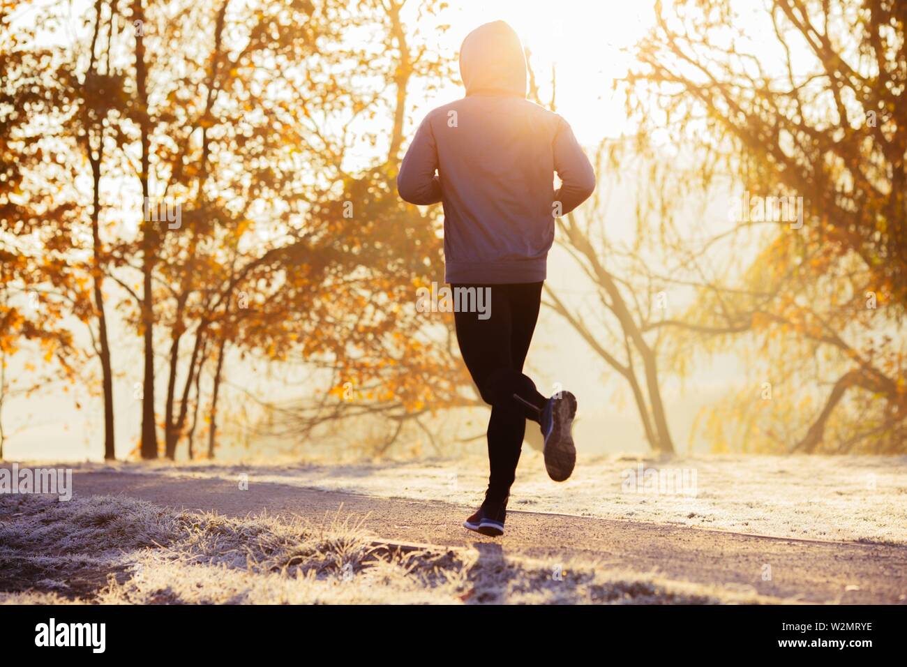 Young man running during autumn, winter morning. Healthy lifestyle ...