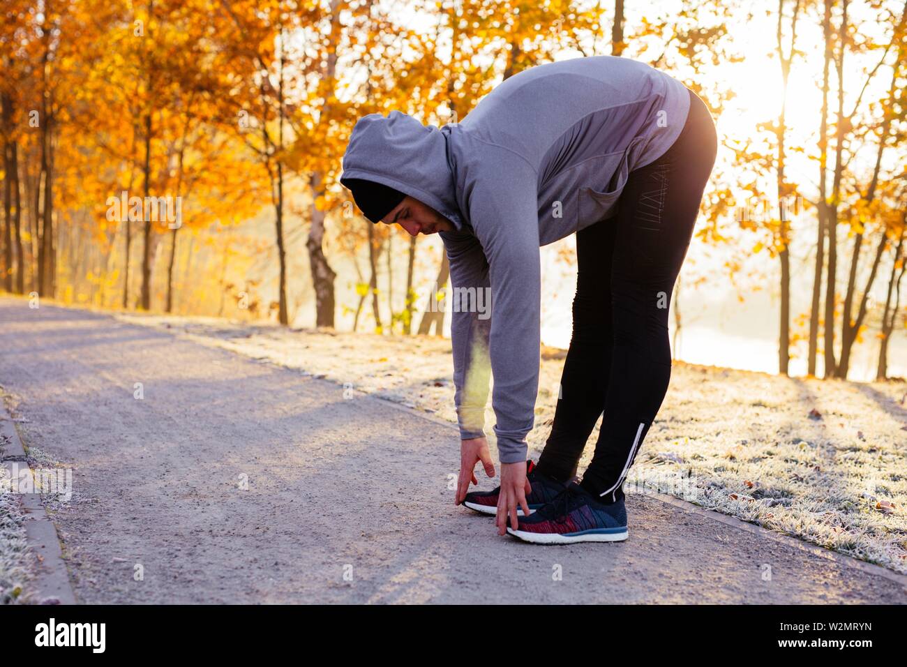 Young runner stretching before hi-res stock photography and images - Alamy