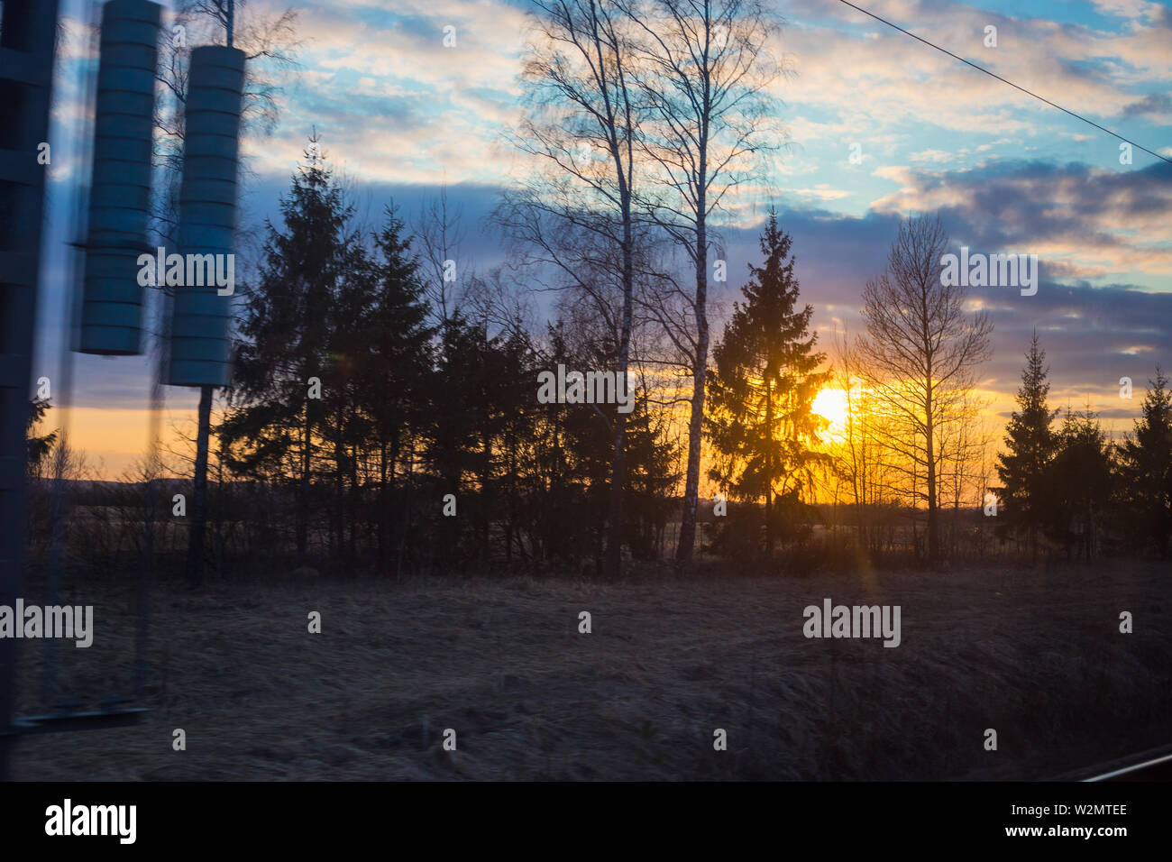 Train window view with dramatic sunset light Stock Photo - Alamy