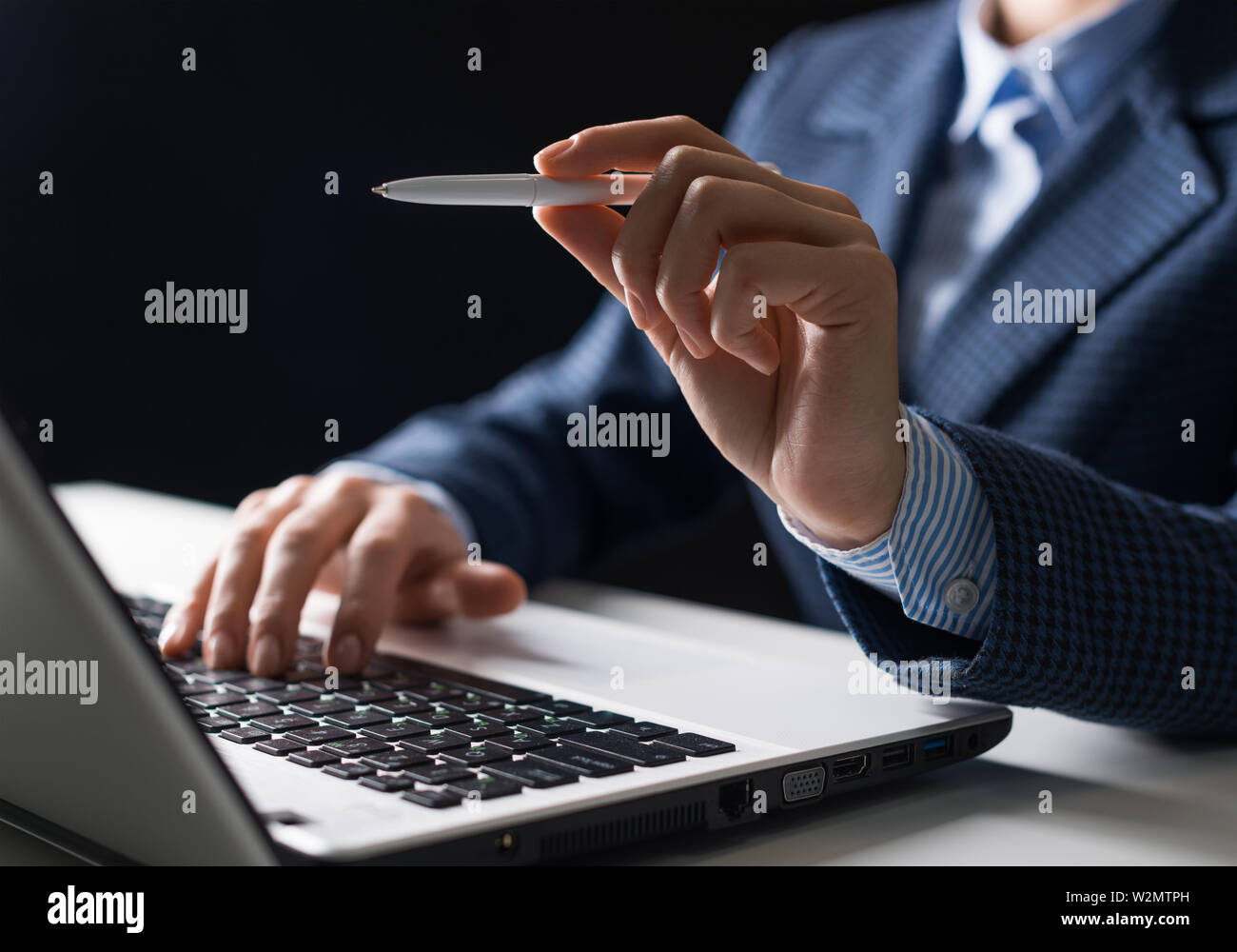 Man in business suit sitting at desk with laptop Stock Photo - Alamy