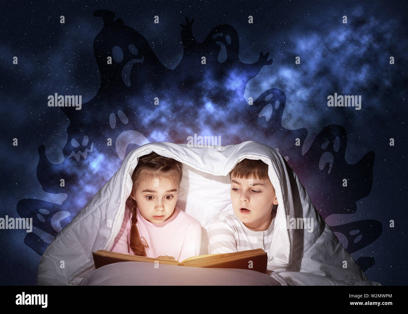 Enthusiastic little girl and boy reading book Stock Photo - Alamy