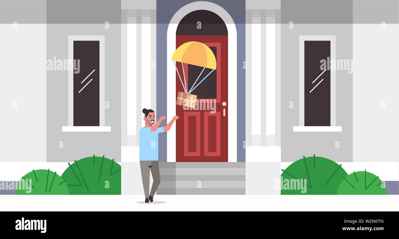 man catching parcel box falling down with parachute from sky ...