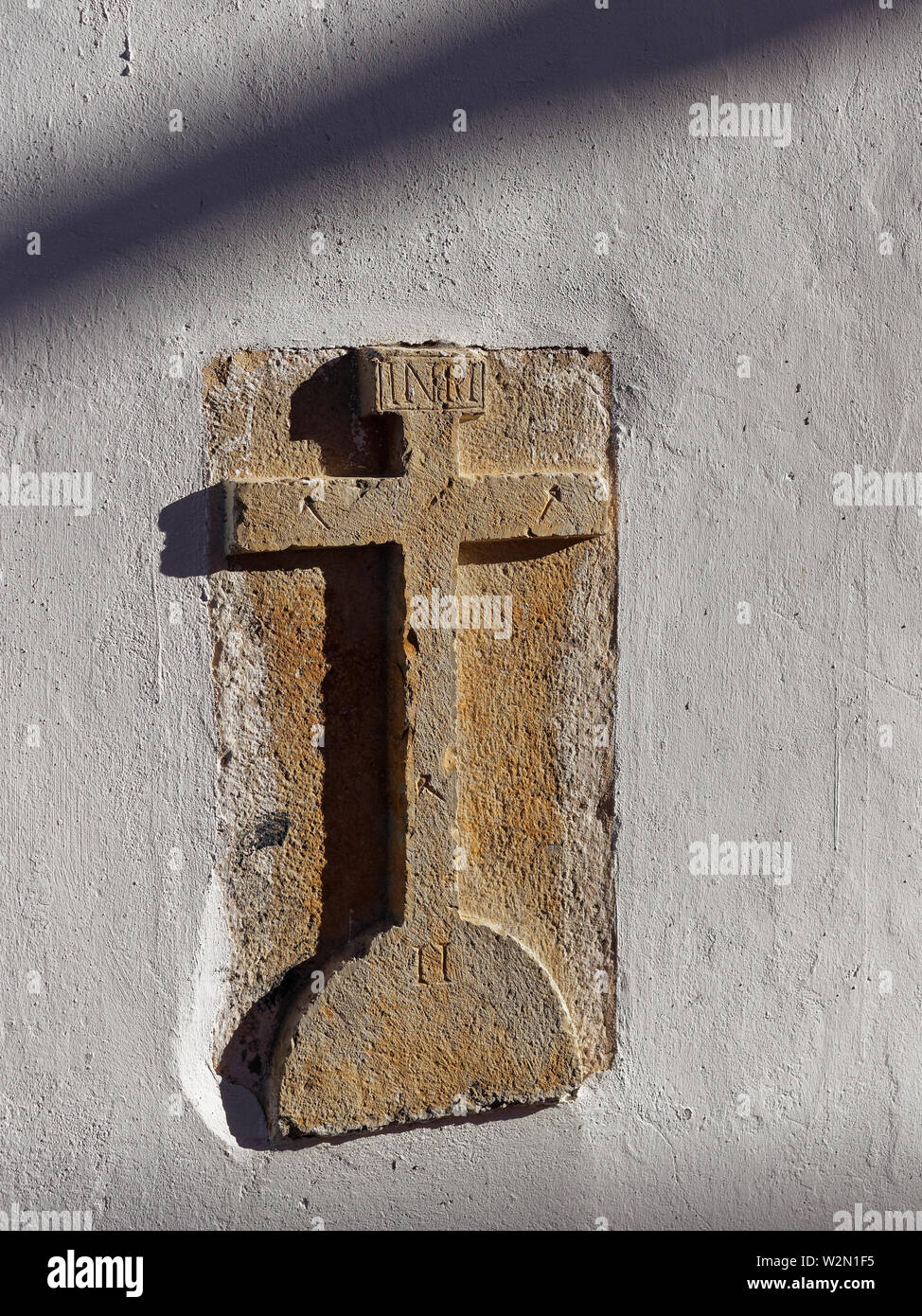 A Carved Stone Cross embedded into the Walls of a House in a street of ...