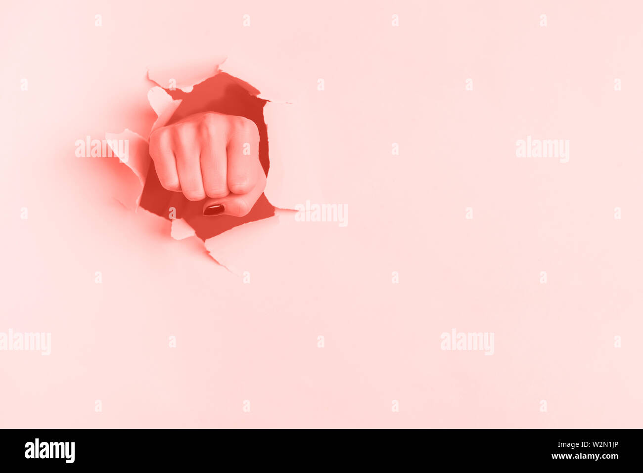 Fist punching through paper hi-res stock photography and images - Alamy