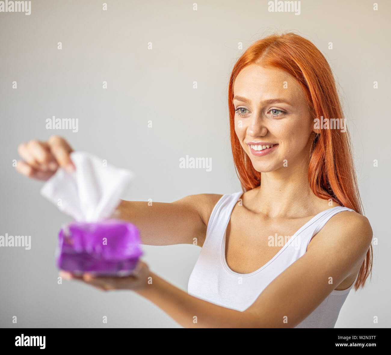 Wet wipes are universal an practical: red-hair women take one wipe from ...