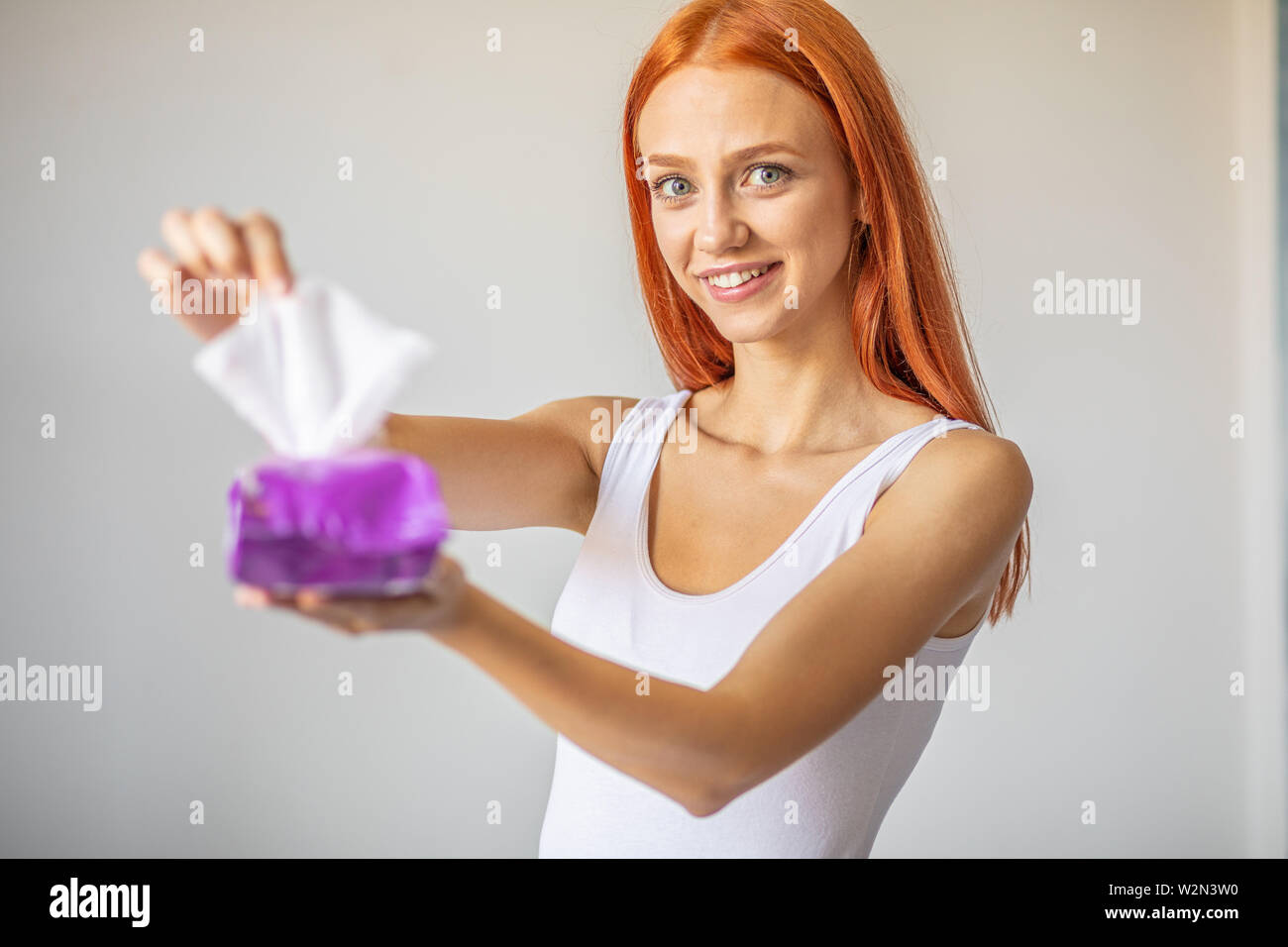 Wet wipes are universal an practical: red-hair women take one wipe from ...