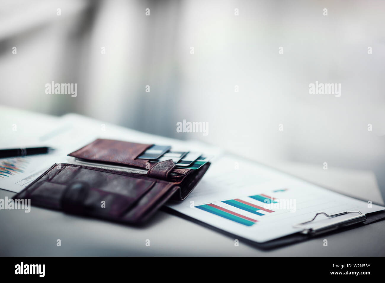 leather wallet and financial chart on the table at the businessman ...