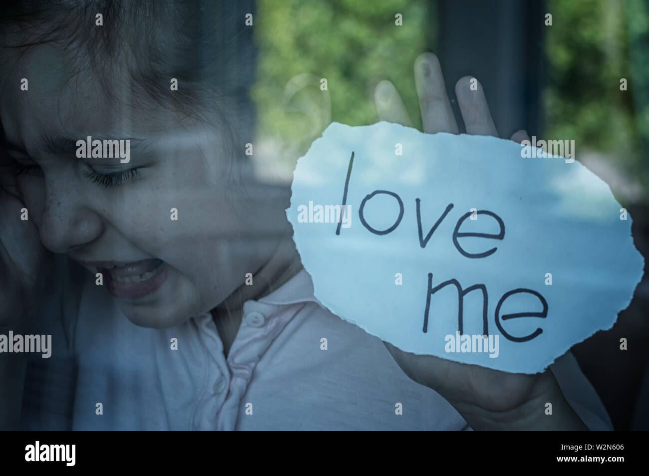 girl crying at the window with a note in his hand Stock Photo - Alamy