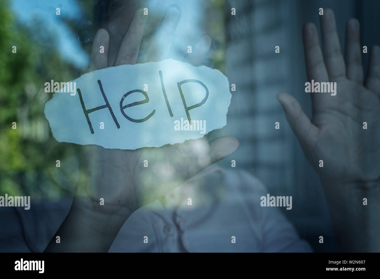girl crying at the window with a note in his hand Stock Photo - Alamy