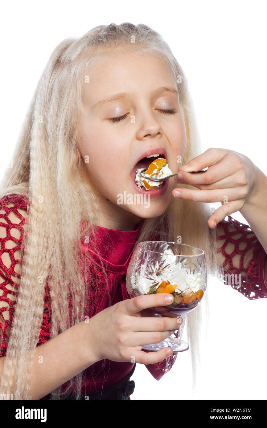 Beautiful blonde girl eating dessert on white background Stock Photo ...