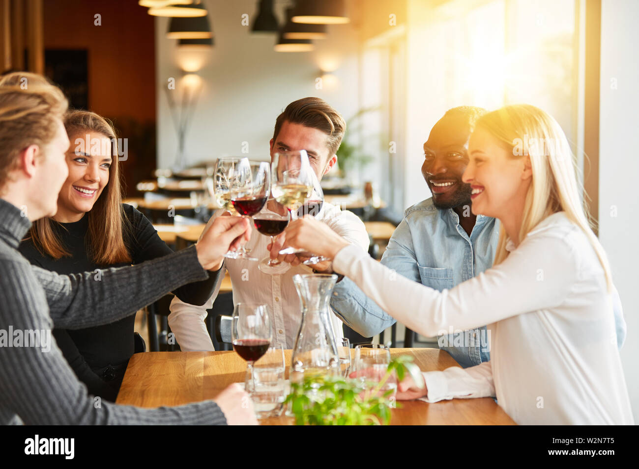 Friends start off with a glass of wine at birthday in the restaurant ...