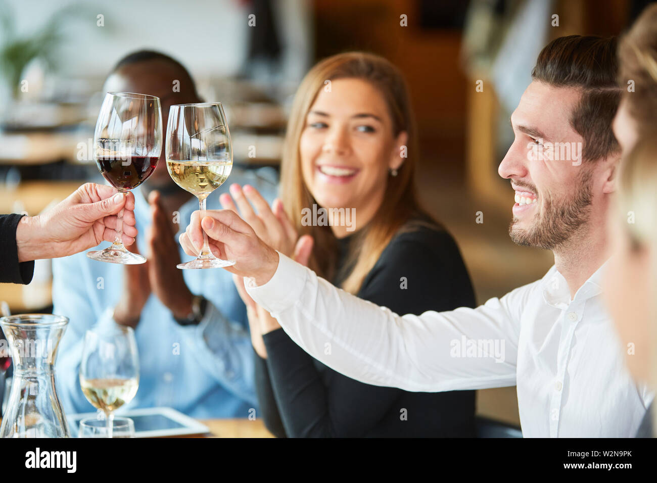 Couple toasting with wine glasses in a bar hi-res stock photography and ...