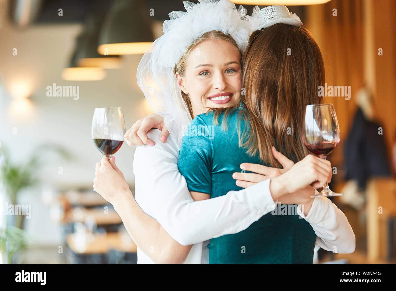 Young woman as a happy bride hugs girlfriend at the hen night Stock ...