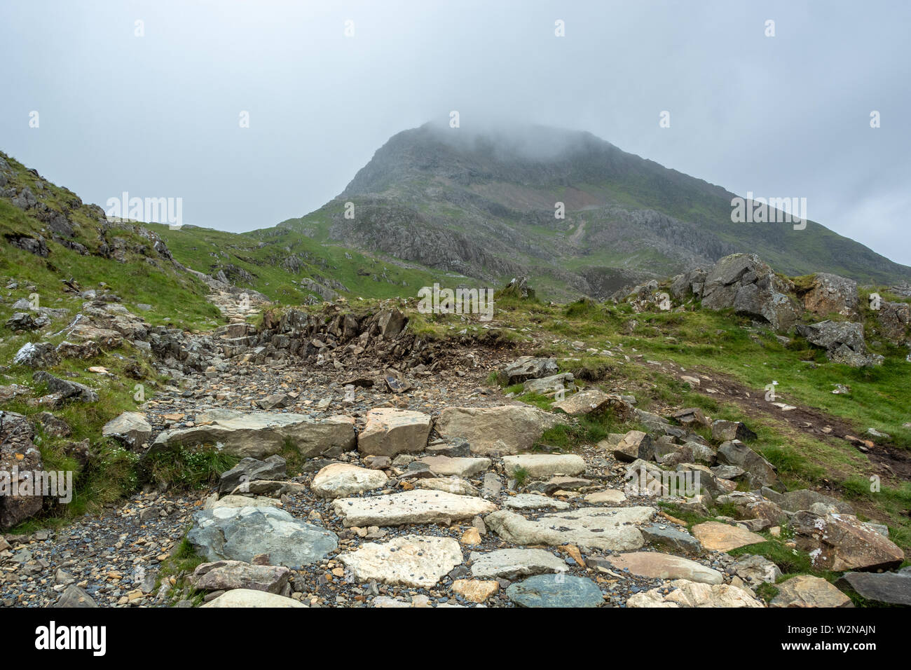 PYG track hiking route up to foggy Snowdon mountain summit on overcast ...