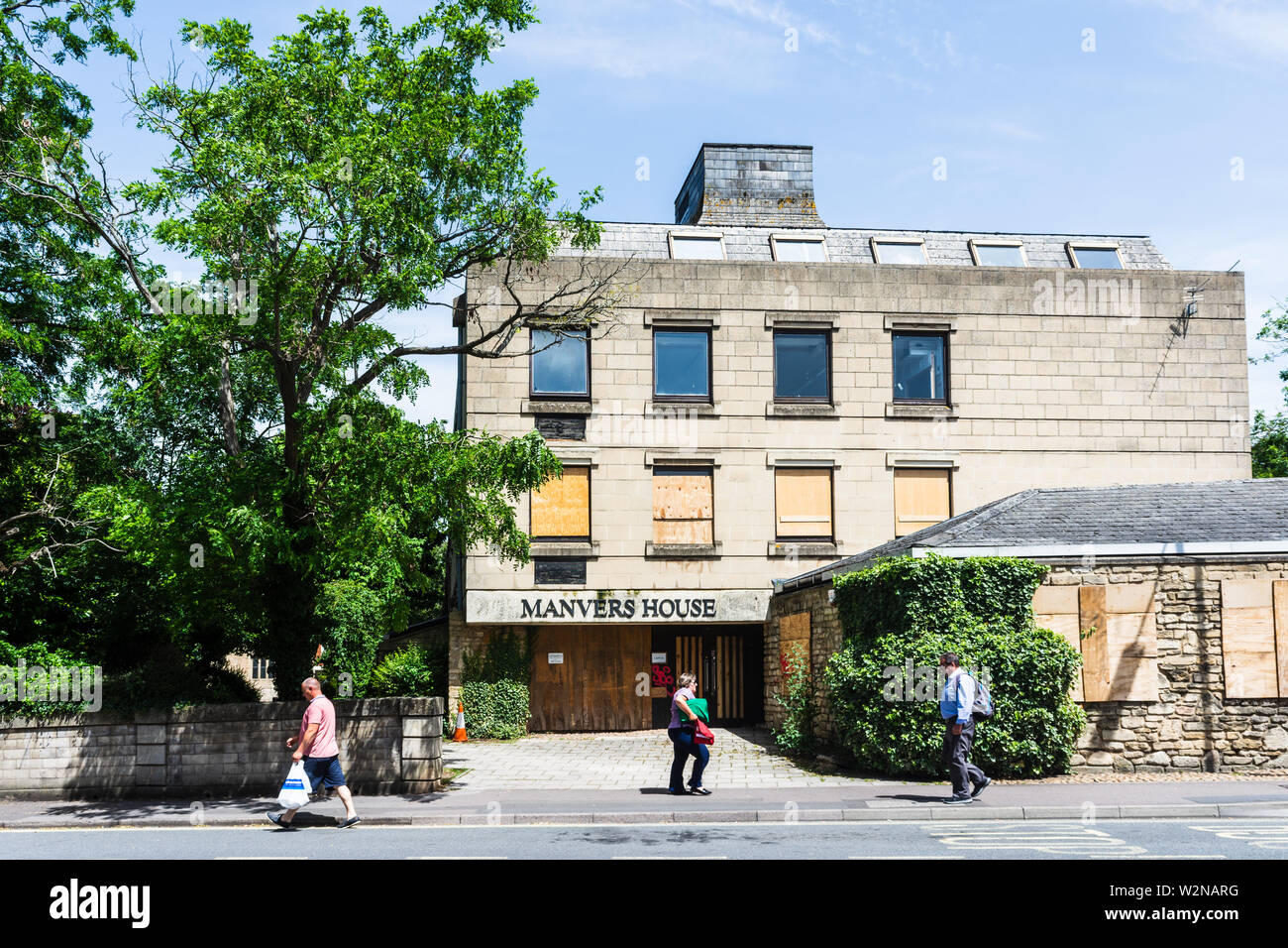 A vacant rather delapidated office building with boarded up windows ...