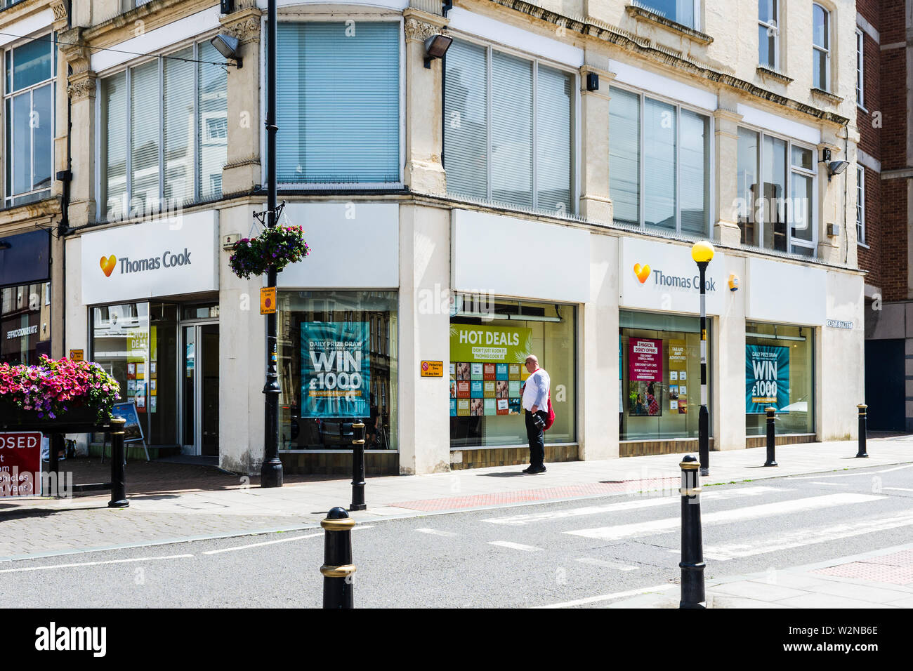A man browsing the window of the travel agents Thomas Cook in the Town ...