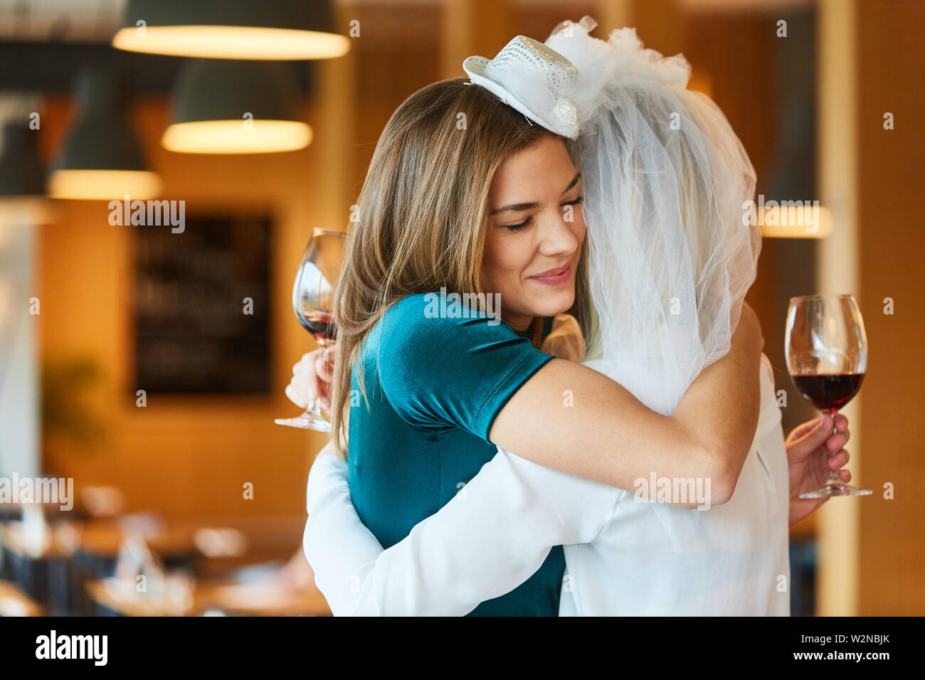 Bride and best friend happily hug each other at hen party Stock Photo ...