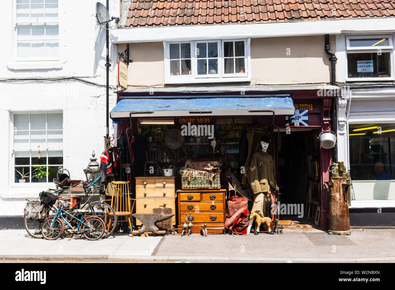 A collection of bric-a-brac and antiques on the pavement outside the ...