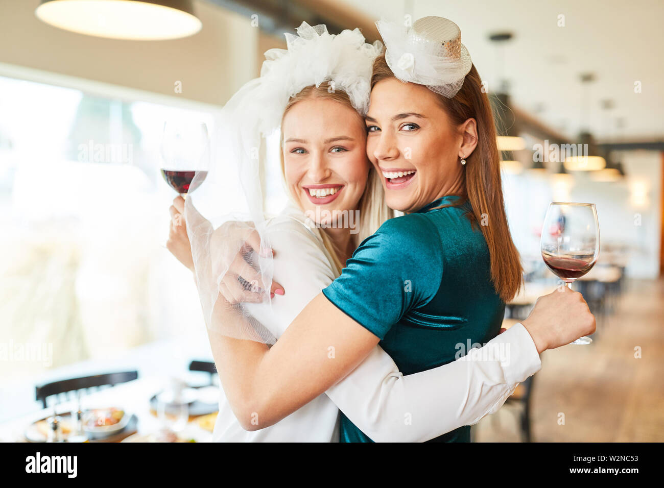 Happy bride hugs her best friend on the hen night Stock Photo - Alamy