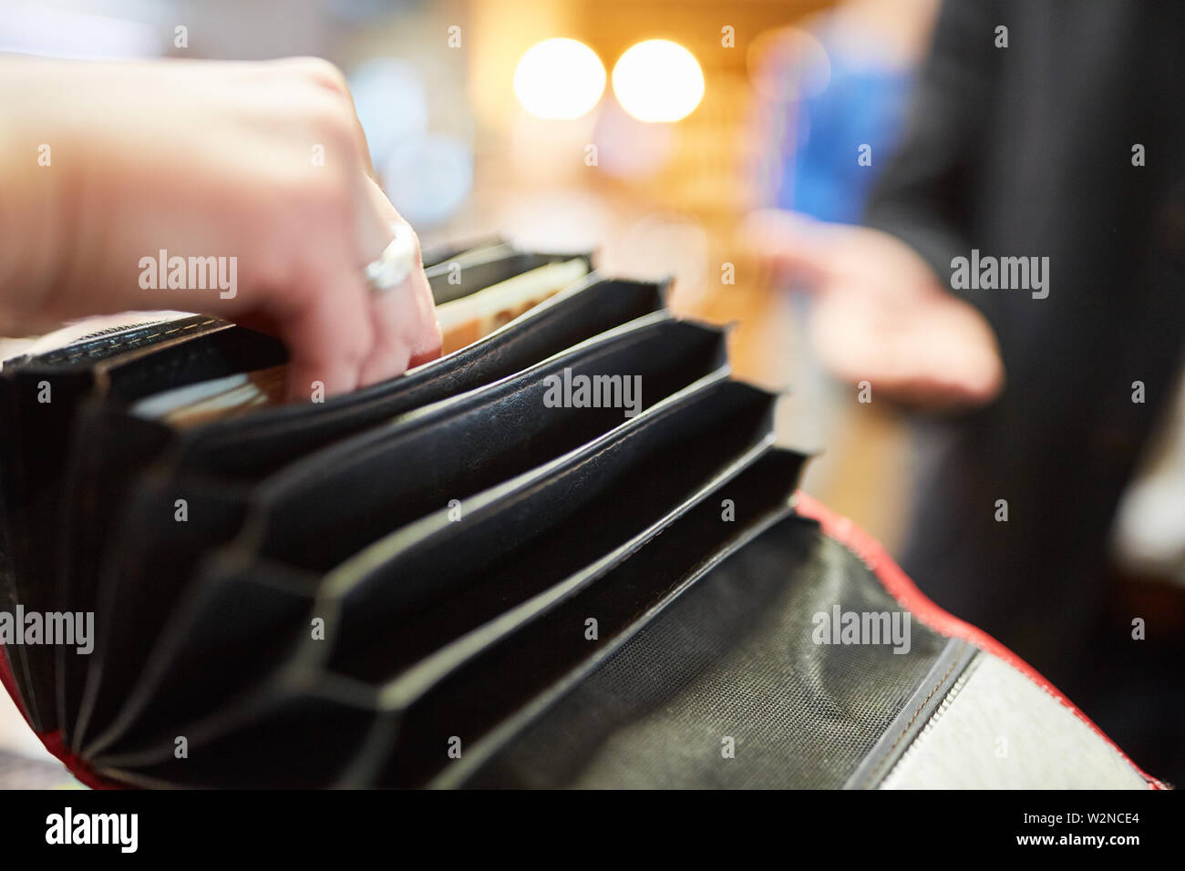 Man looking in the wallet for a bill while paying with cash Stock Photo ...