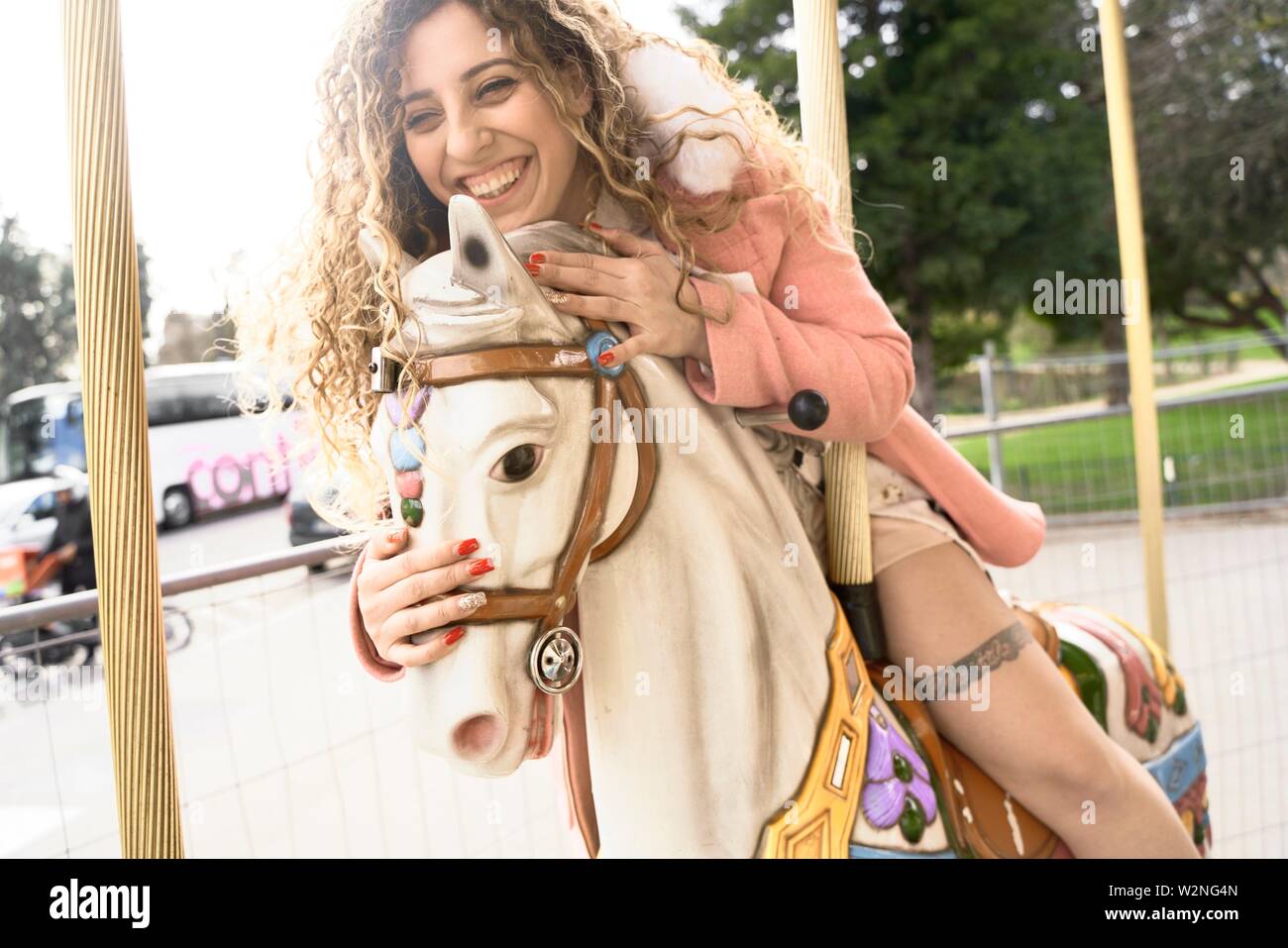 Young woman riding carousel hi-res stock photography and images - Alamy