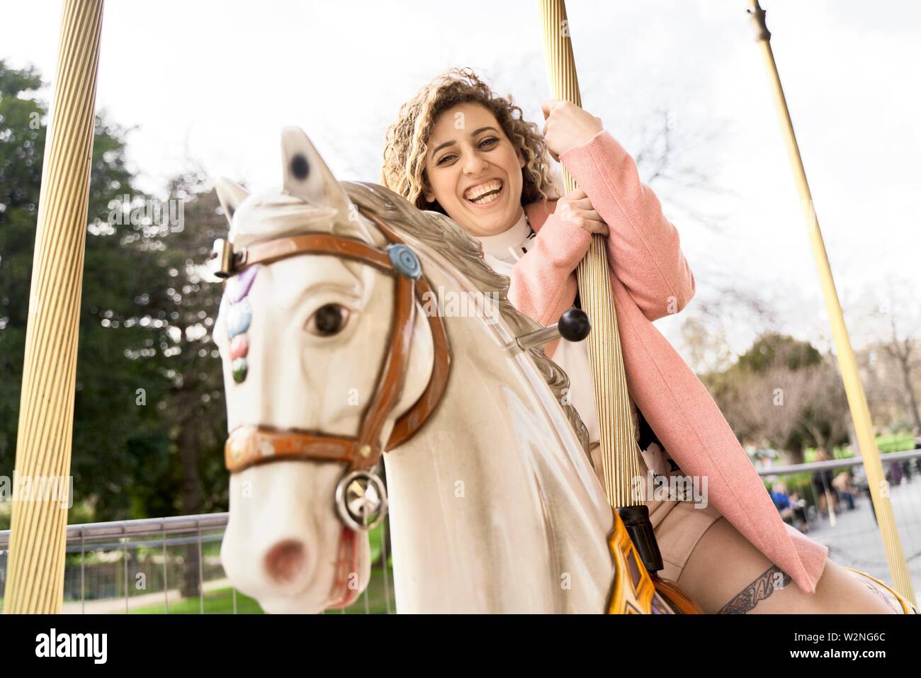 Young woman riding carousel hi-res stock photography and images - Alamy