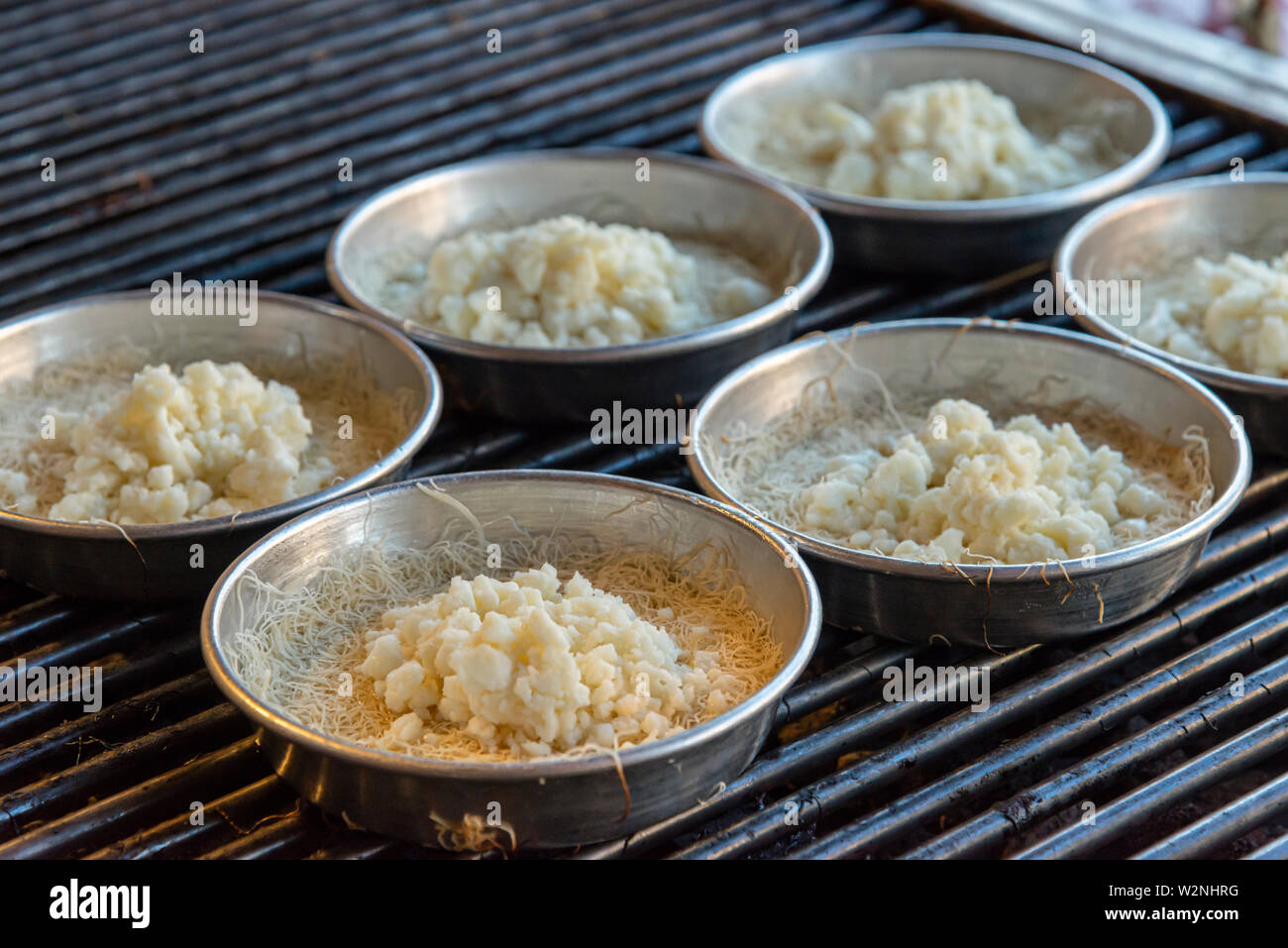 Preparing personal knafeh in a tray Stock Photo - Alamy