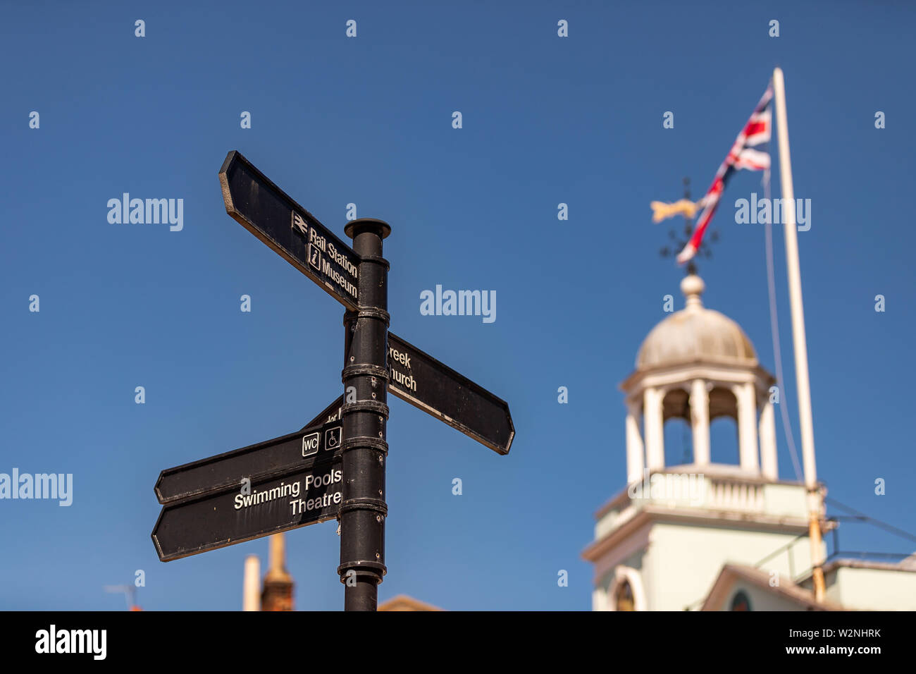 Black signpost with directions to places in Faversham. Faversham Guild ...