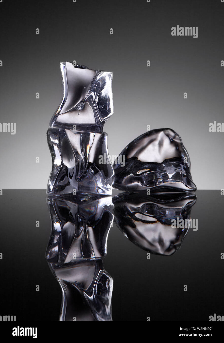 Three ice cubes crystal object with water on mirror background Stock ...