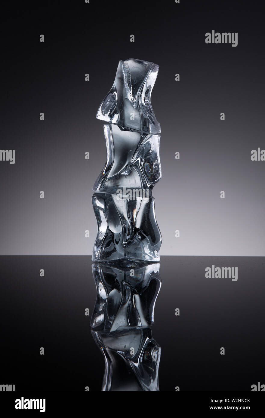 Three ice cubes with water on mirror background Stock Photo - Alamy