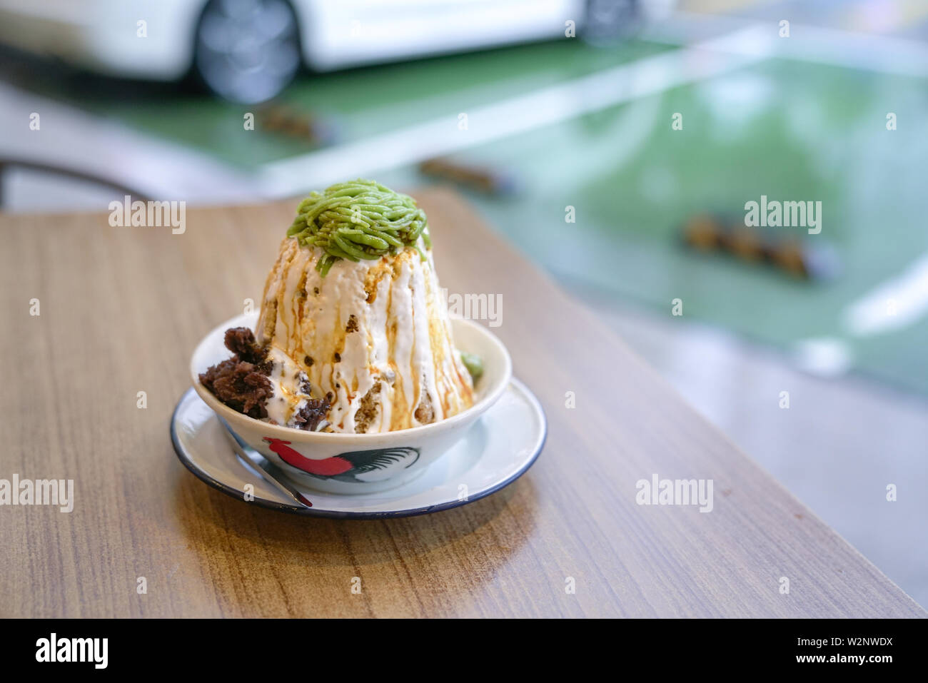 Bowl of Cendol on a table. It an iced sweet dessert that contains green ...
