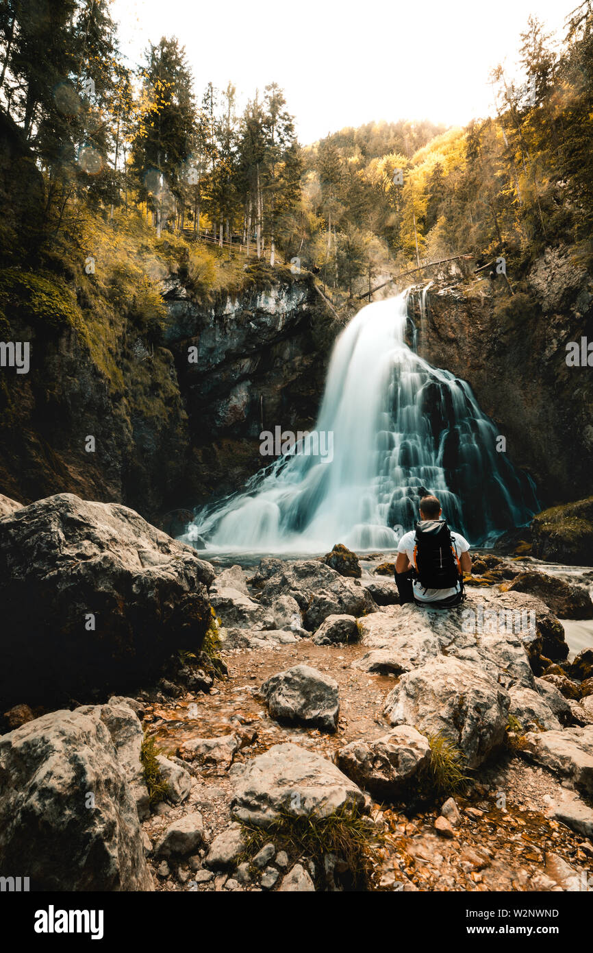 Man sitting near waterfall hi-res stock photography and images - Alamy