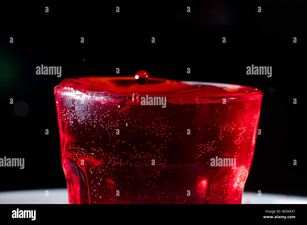 drops of red liquid in glass beaker Stock Photo - Alamy