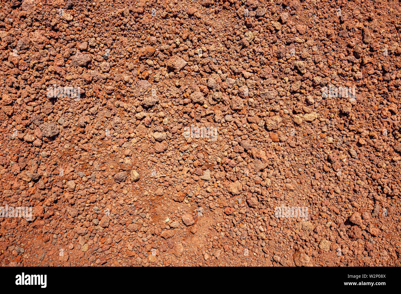 Volcanic slag scattered at the foot of the volcano, the background of ...