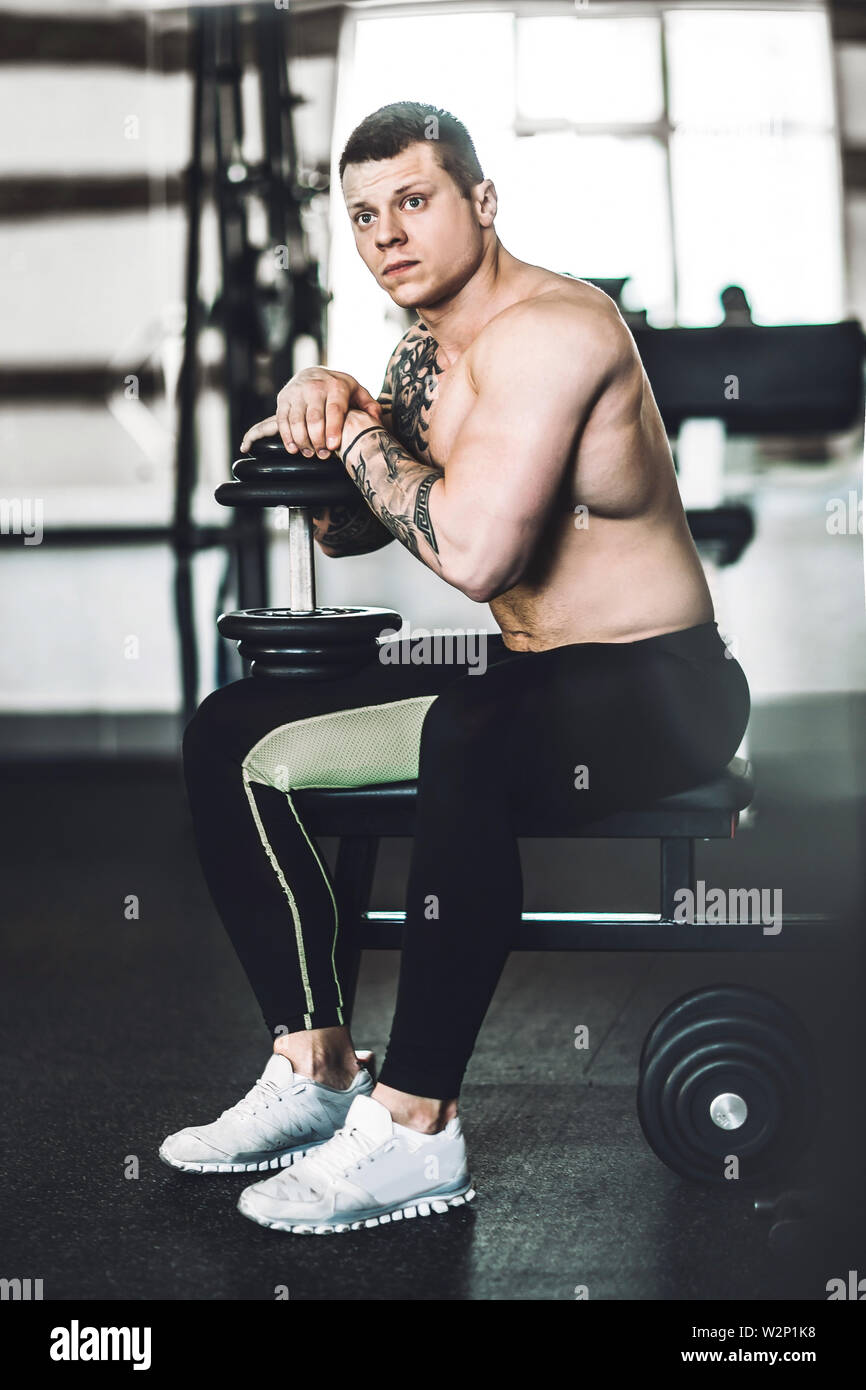 portrait of a brooding male bodybuilder in the gym . photo with copy ...