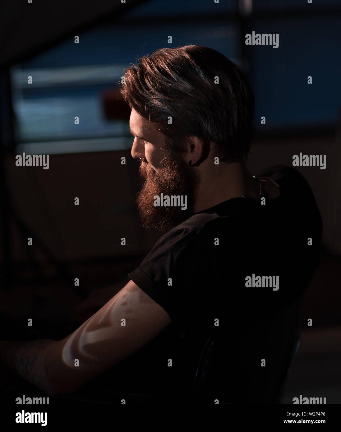 rear view. bearded serious man sitting in a chair Stock Photo - Alamy